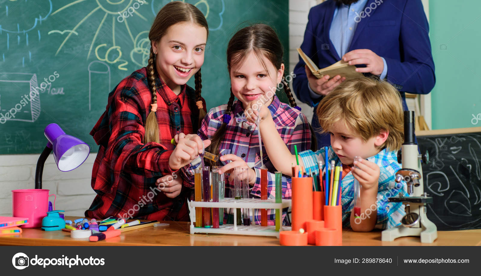 Doing experiments with liquids in chemistry lab. children making ...