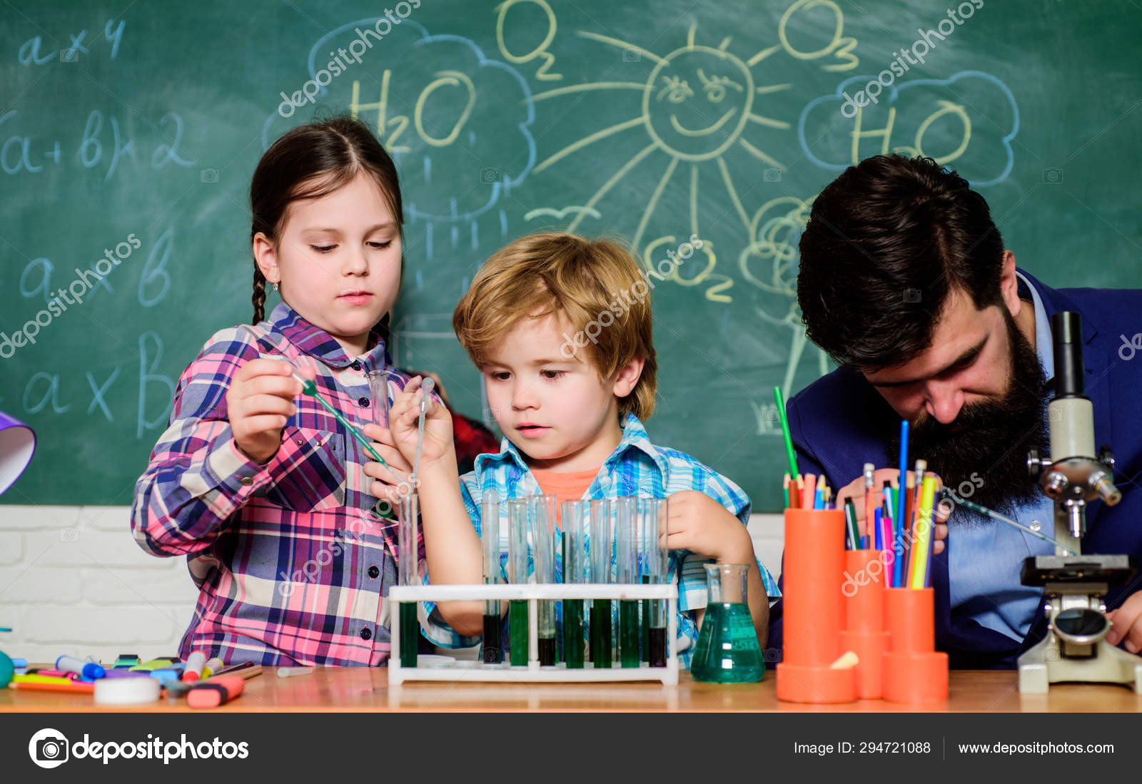 Students doing science experiments with microscope in lab. school kids ...