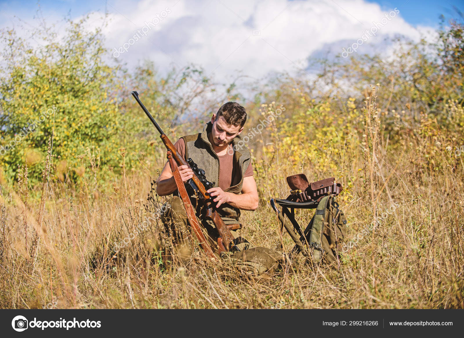Man with rifle hunting equipment nature background. Recharge rifle ...