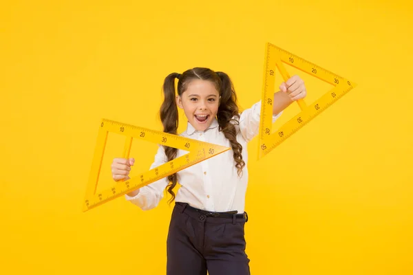 Look at the triangle with two equal sides. Happy little schoolgirl ...