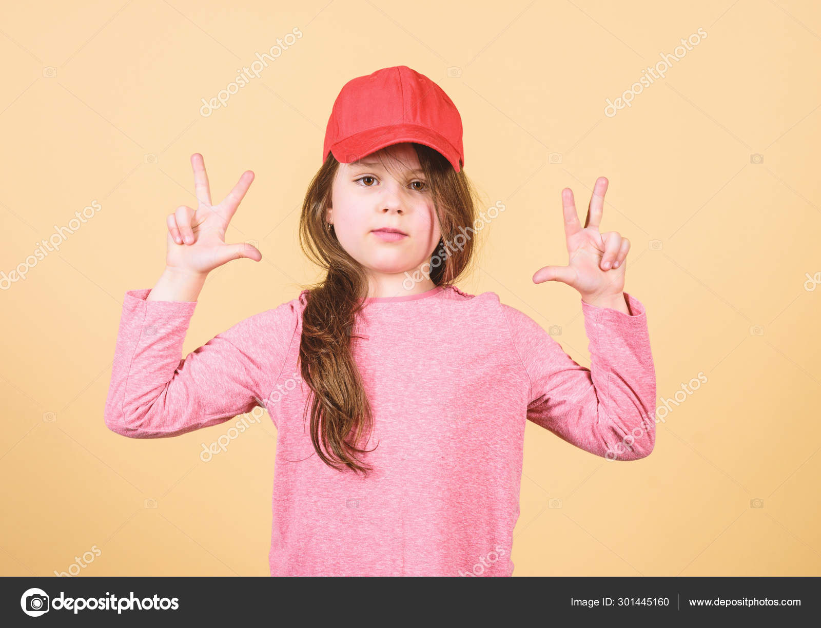 Girl cute child wear cap or snapback hat beige background. Little girl ...