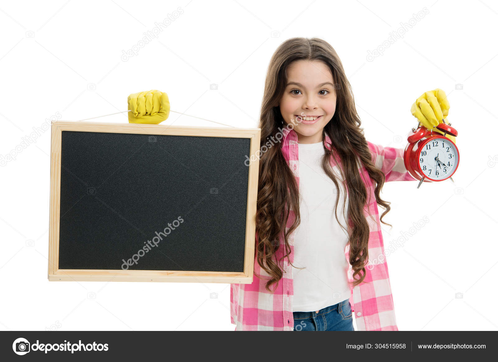 Its class time. Happy little girl holding blank blackboard and alarm ...
