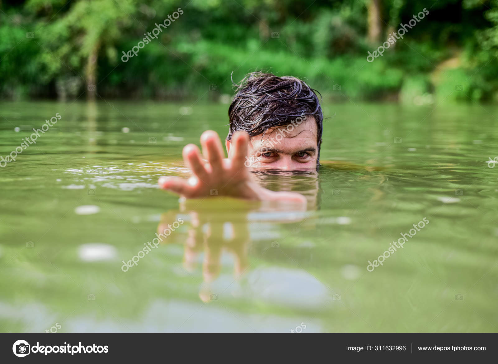 Scary man comes from deep water. bearded man swimming in lake. summer ...