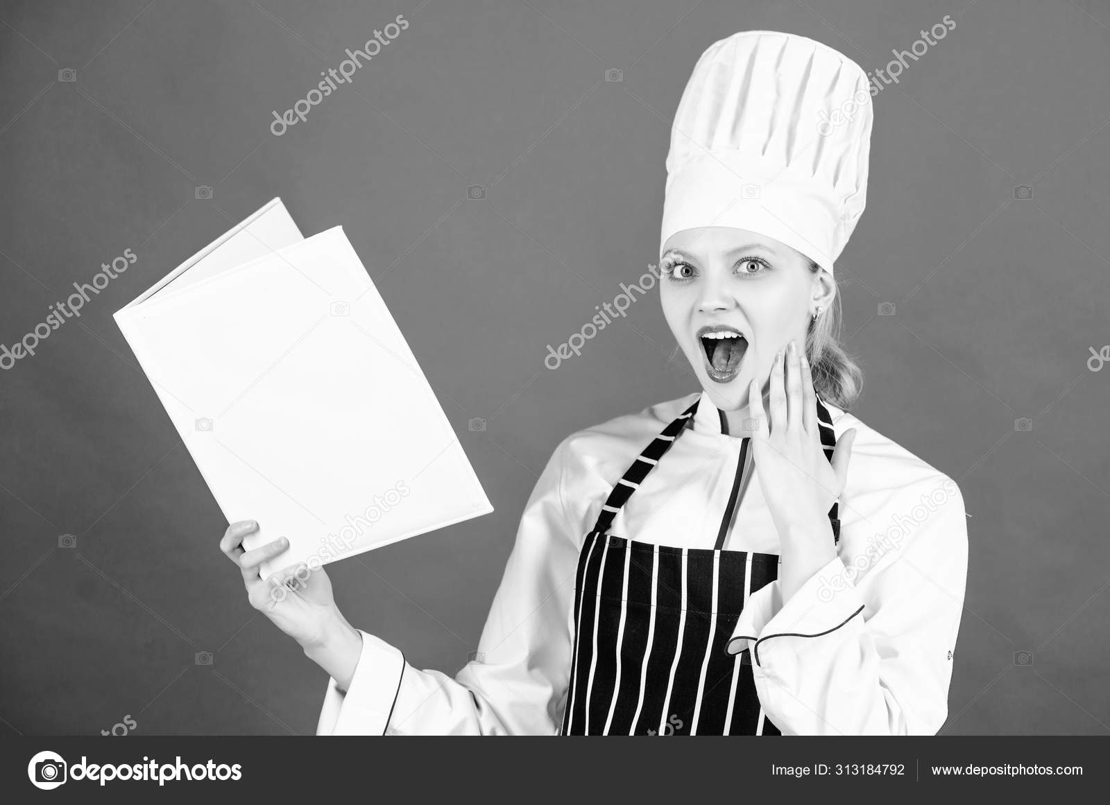 Cooking food and culinary as hobby. Woman reading cook book in kitchen ...