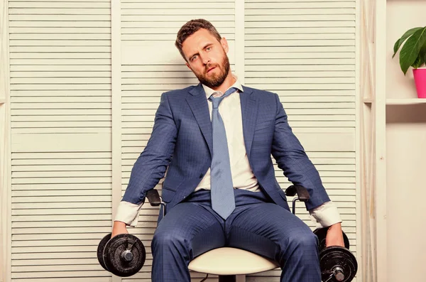 should work for success. challenging himself. businessman hold dumbbell ...