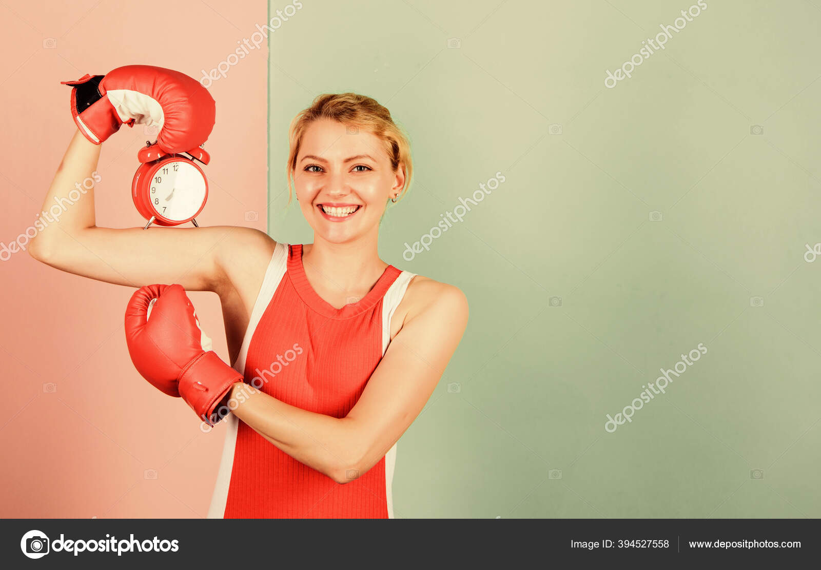 Punctuality and personal efficiency. girl boxer hold alarm clock ... Punctuality and personal efficiency. girl boxer hold alarm clock ...
