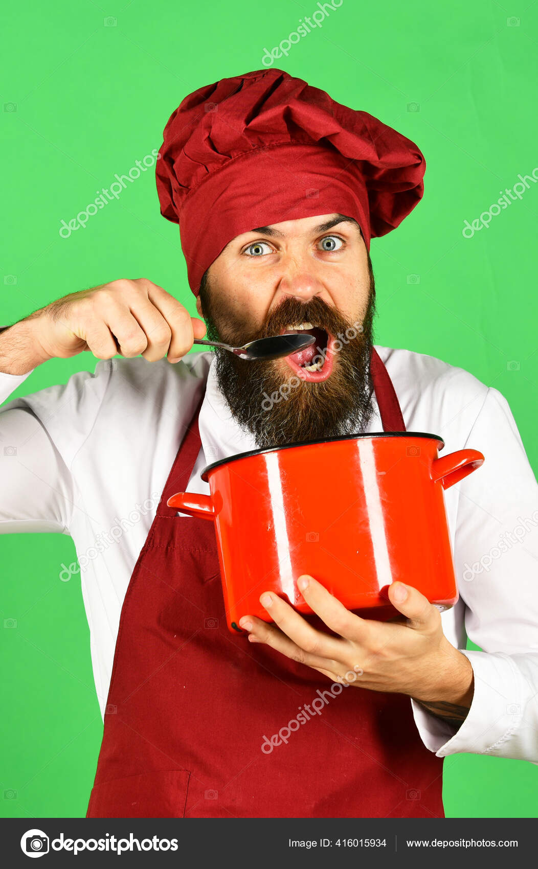 Cook with hungry face in burgundy uniform eats soup — Stock Photo ...