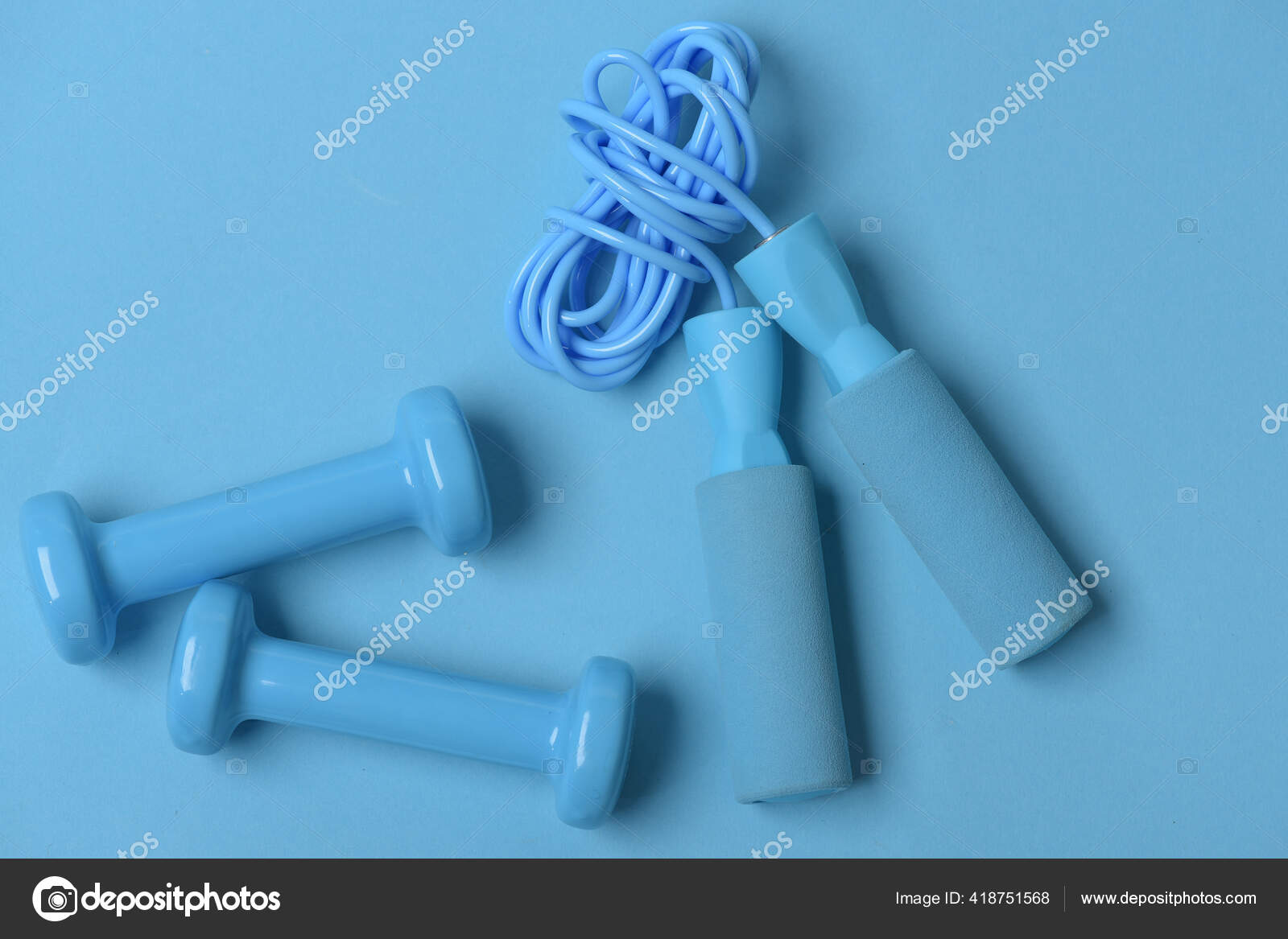 Jump rope and barbells placed next to each other Stock Photo by ...