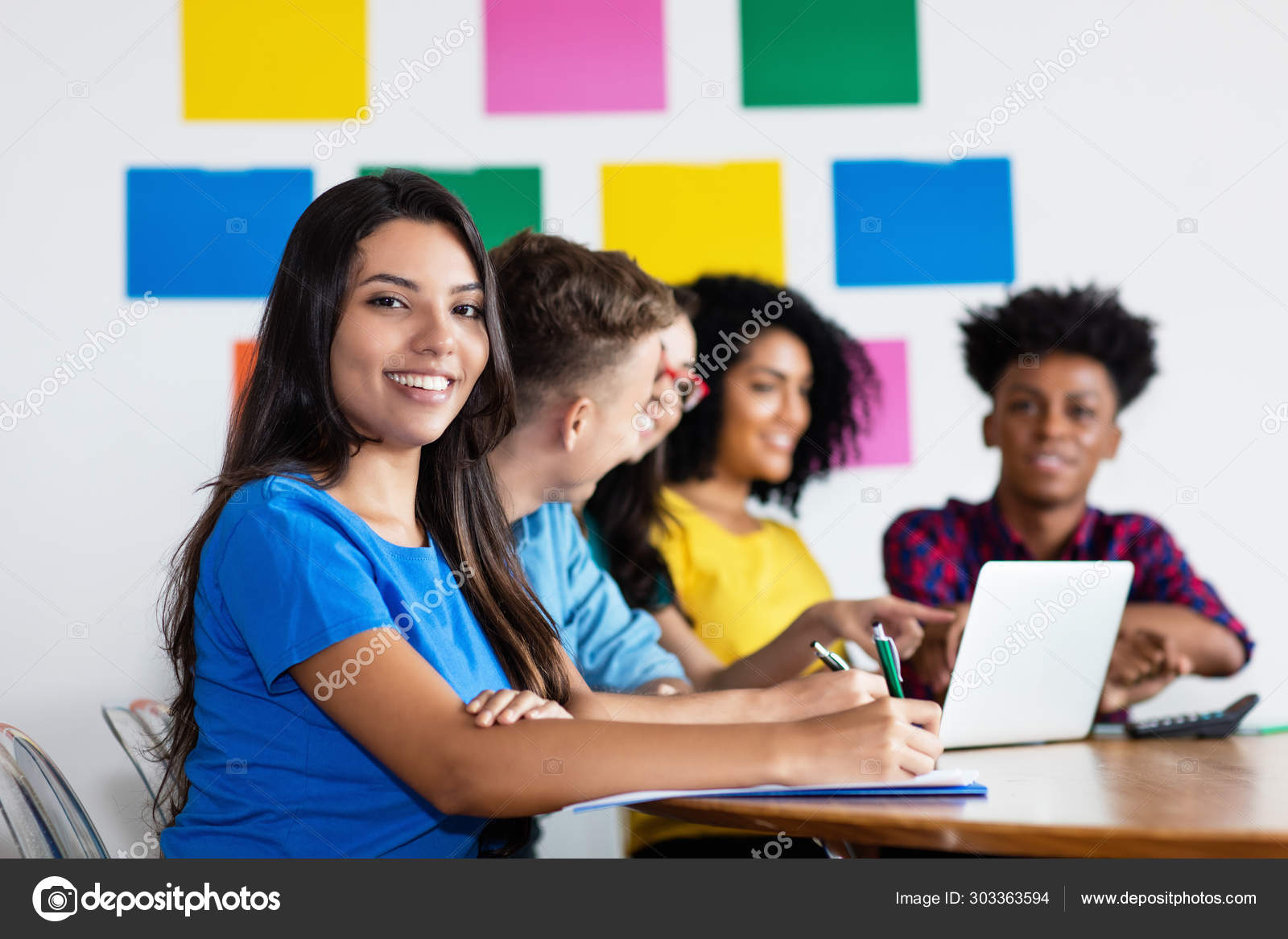 Laughing hispanic female student with group of creative students ...
