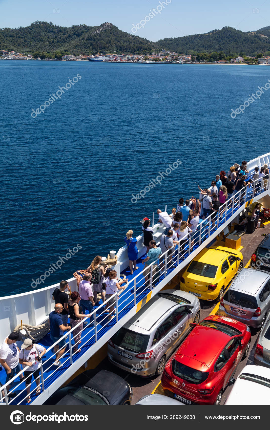Big ferry boat deck with passengers and cars, runs from Keramoti ...