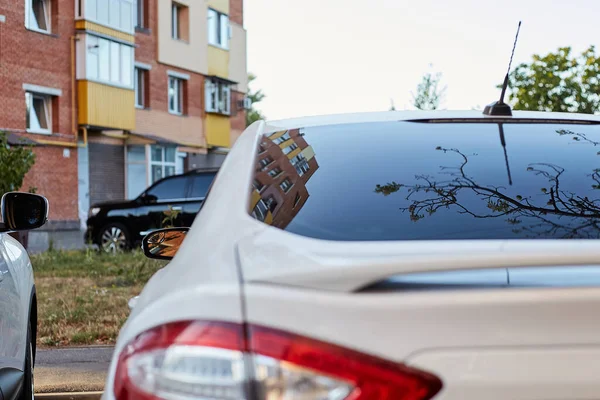 Back window of red car parked on the street in summer sunny day, rear ...