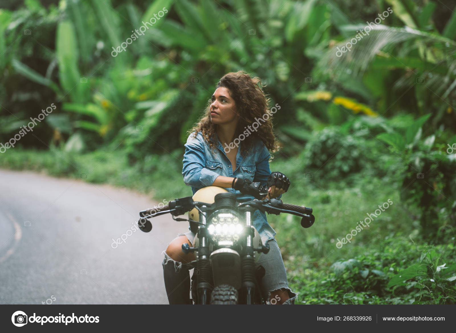 Female biker driving a cafe' racer motorbike Stock Photo by ...