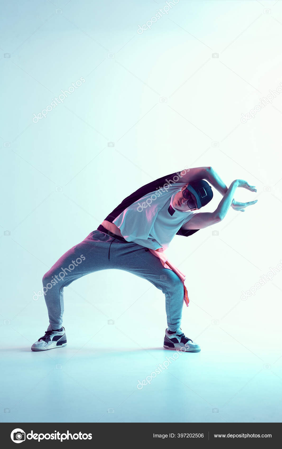 Cool young breakdancer guy dance in studio in neon light. Dance school ...