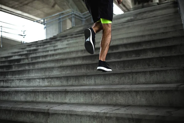 Rear view of strong legs of professional male runner - Stock Image ...