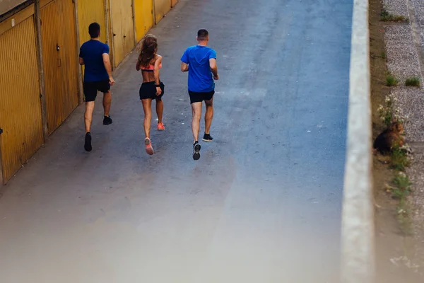 Rear View Three Professional Athletes Jogging Alleyway Garages — Stock ...