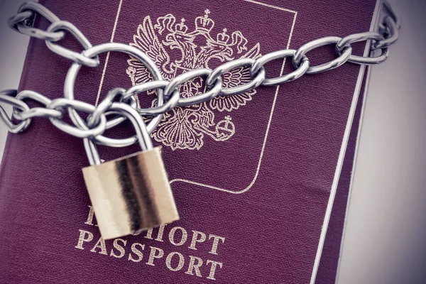 Russian Passports covered with a chain with a golden Lock. Toned ...