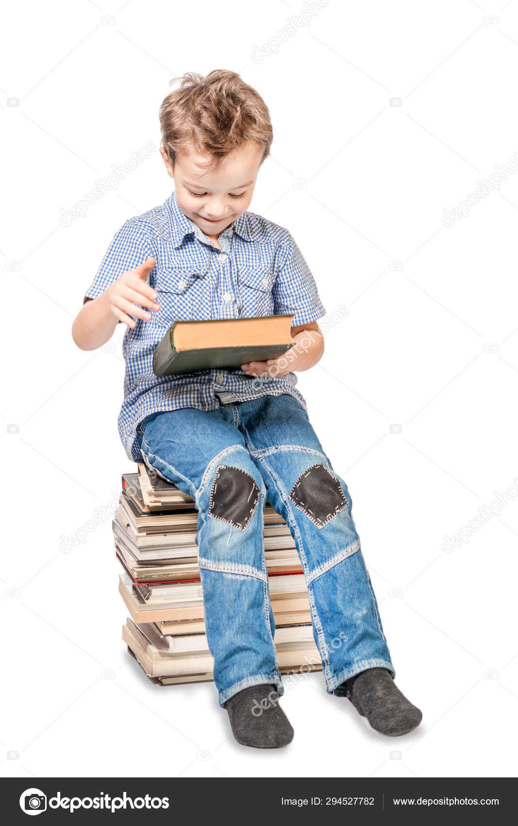 Cute smiling boy with a book is sitting on a pile of books. Isol Stock ...