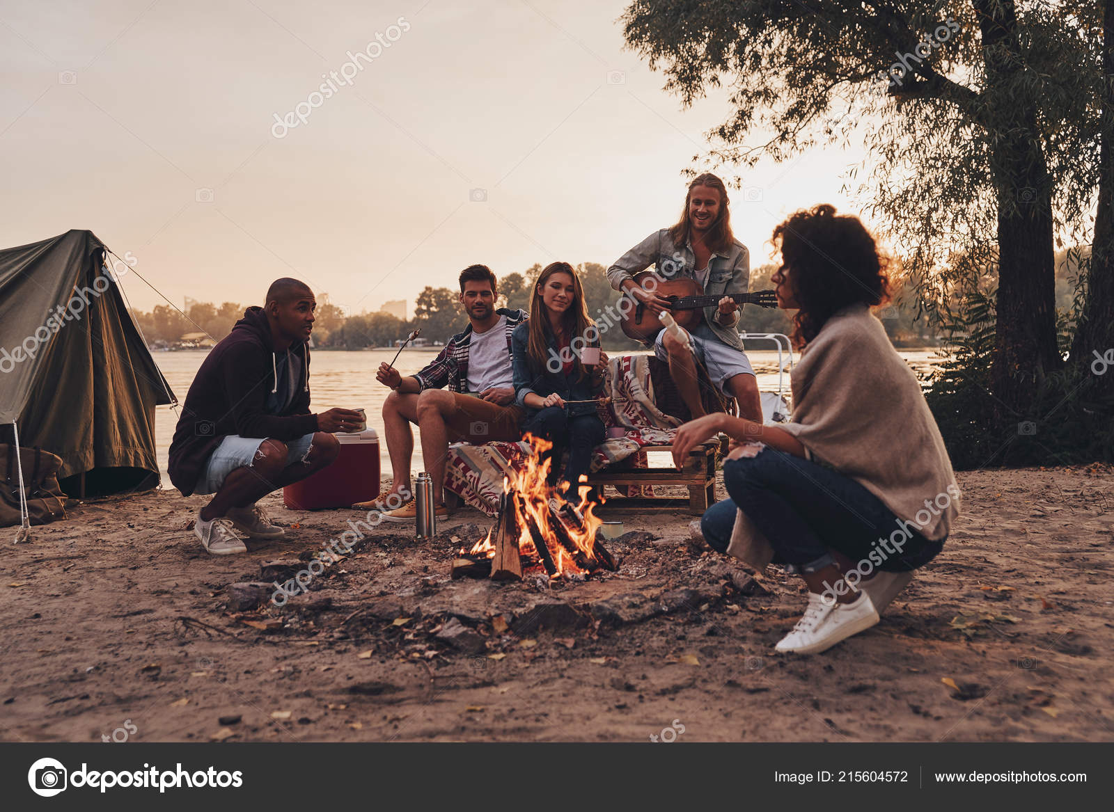 Friends Casual Wear Smiling While Enjoying Beach Party Campfire — Stock Photo © gstockstudio ...