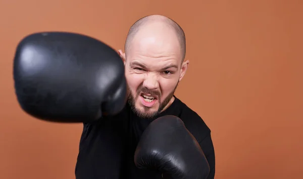 Attractive muscular young boxer with a thick beard, in a black T-shirt ...