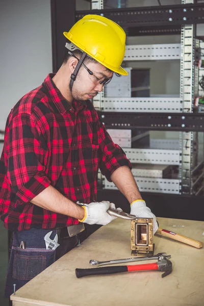 Asian handsome technician work on the desk with tools,Thailand people ...