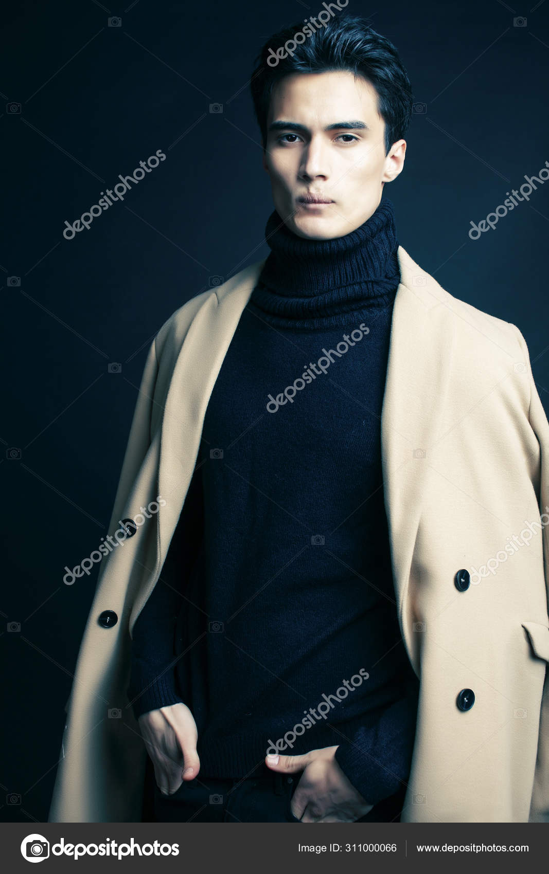 Cool real young man in coat on black background posing, lifestyle ...