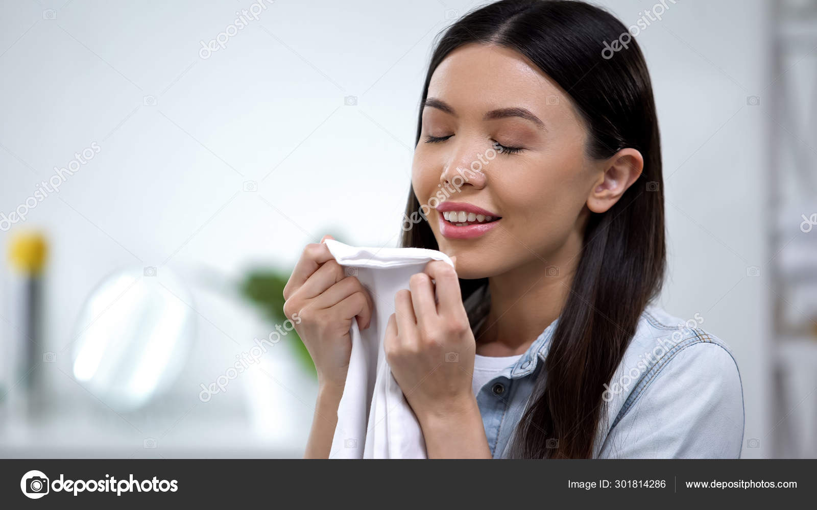 Female Smelling Fresh Linens Smiling Enjoying Fabric Conditioner Aroma ...