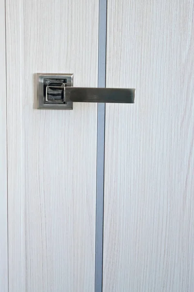 Open door in modern house. Modern wooden door with metal handle close ...