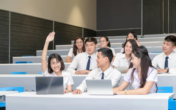 student Raise hands to ask teacher in classroom - Stock Image - Everypixel
