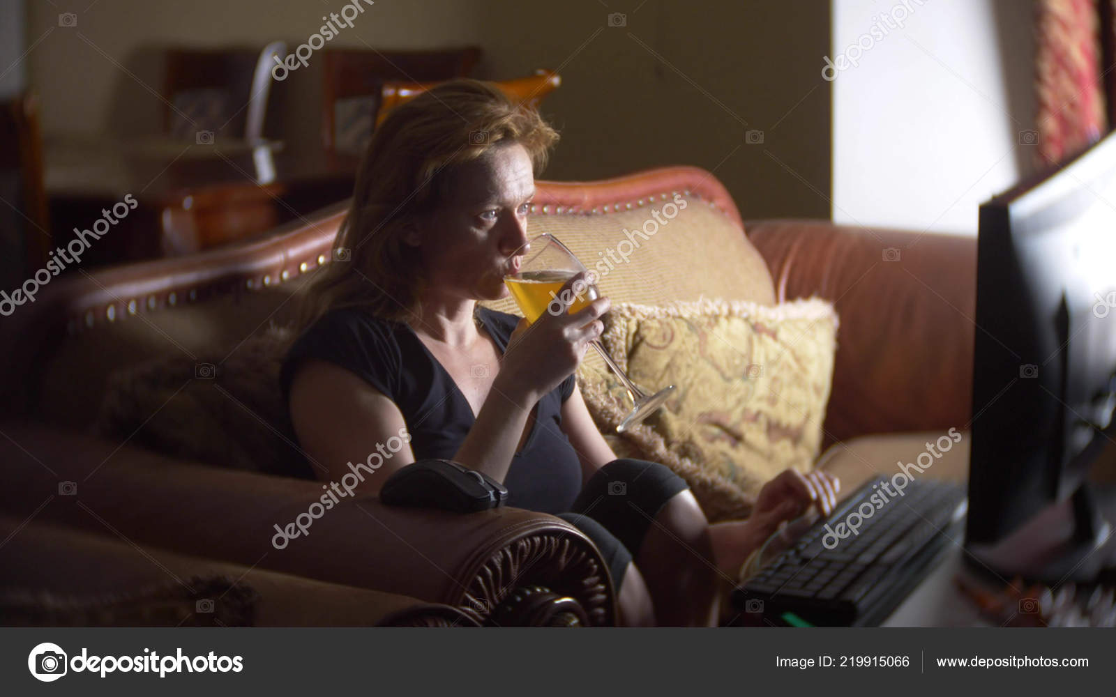 Woman with computer, drinking beer at home in the dark. — Stock Photo ...