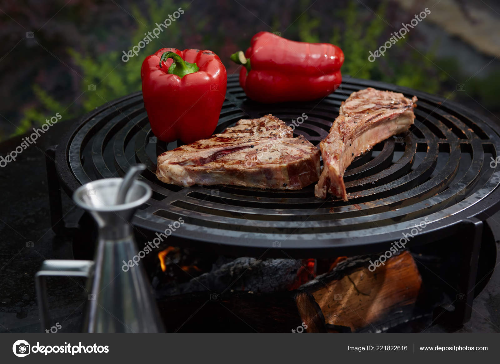 Tomahawk rib beef steak and T-bone on hot black grill. Stock Photo by ...
