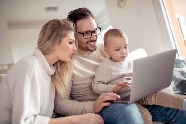 Happy family using technology together in living room. - Stock Image ...