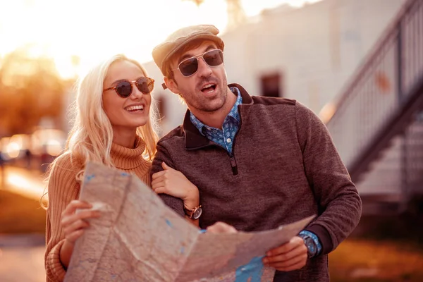 Traveling couple searching for their next destination with a map ...