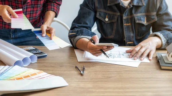 Interior designer and Architect choosing color in color swatch samples ...