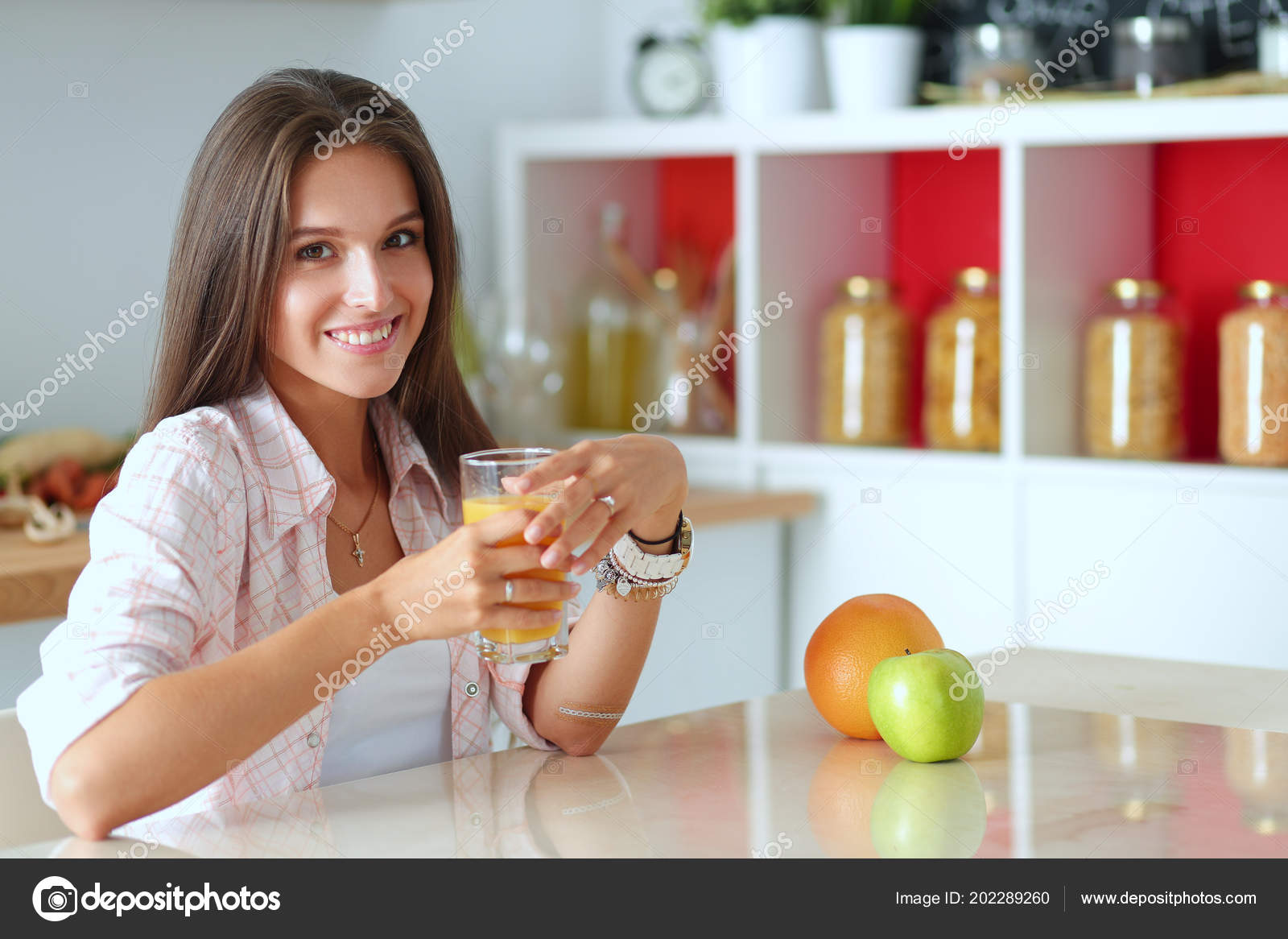 Young woman sitting a table in the kitchen. Young woman Stock Photo by ...