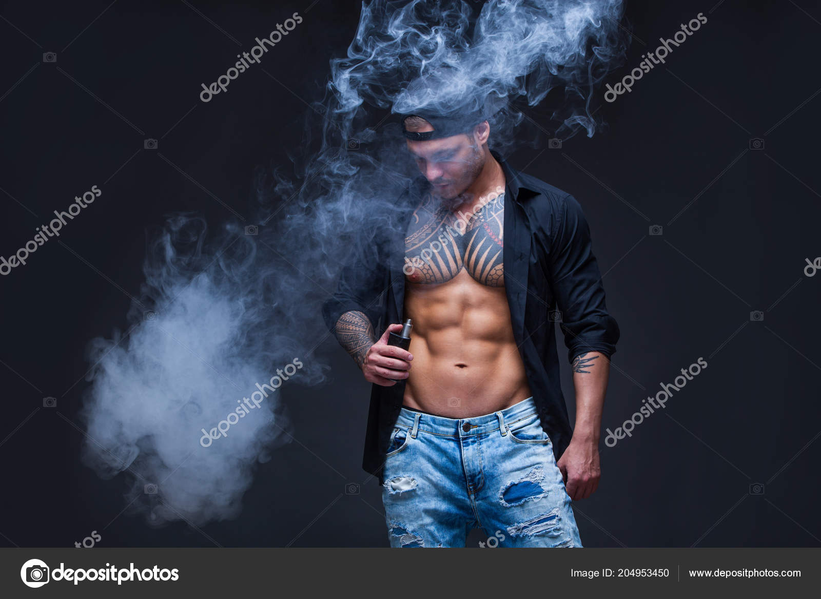 Vaper. The man dressed blue jeans, black shirt and black baseball cap ...