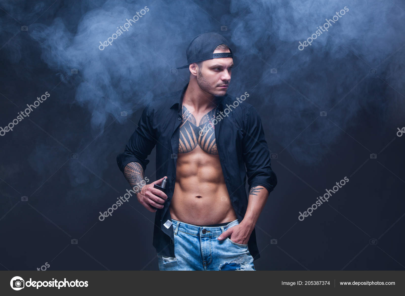 Vaper. The man dressed blue jeans, black shirt and black baseball cap ...