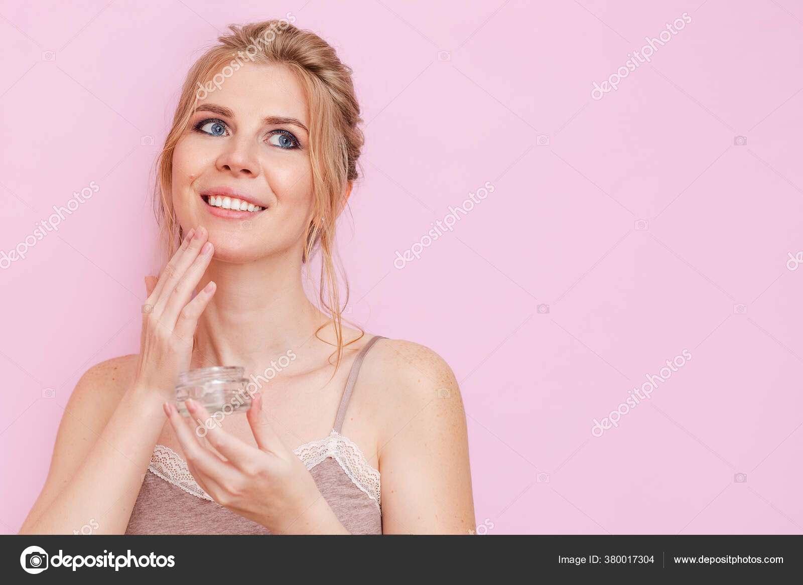 Cute Young Blonde Girl Takes Care Of The Skin Applies Face Cream A