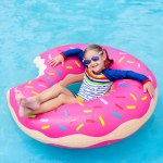 Child in swimming pool on donut float Stock Photo by ©FamVeldman 302137950