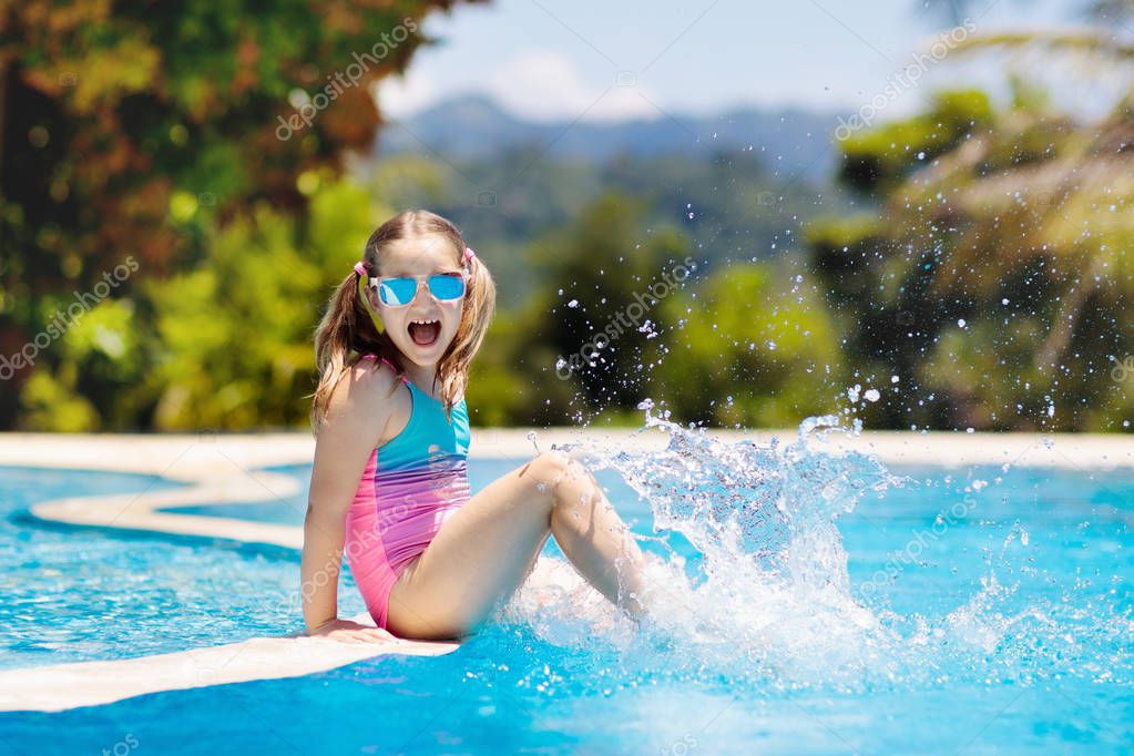 Niño jugando en la piscina. Vacaciones de verano con niños. Niña saltando al agua durante unas ...