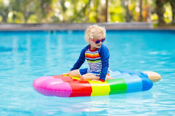 Child in swimming pool on donut float Stock Photo by ©FamVeldman 302137950