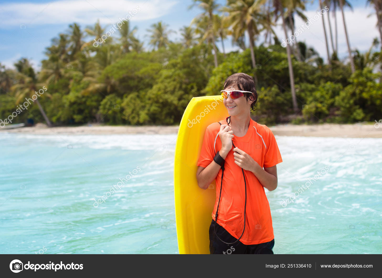 Child surfing on tropical beach. Surfer in ocean. Stock Photo by ...