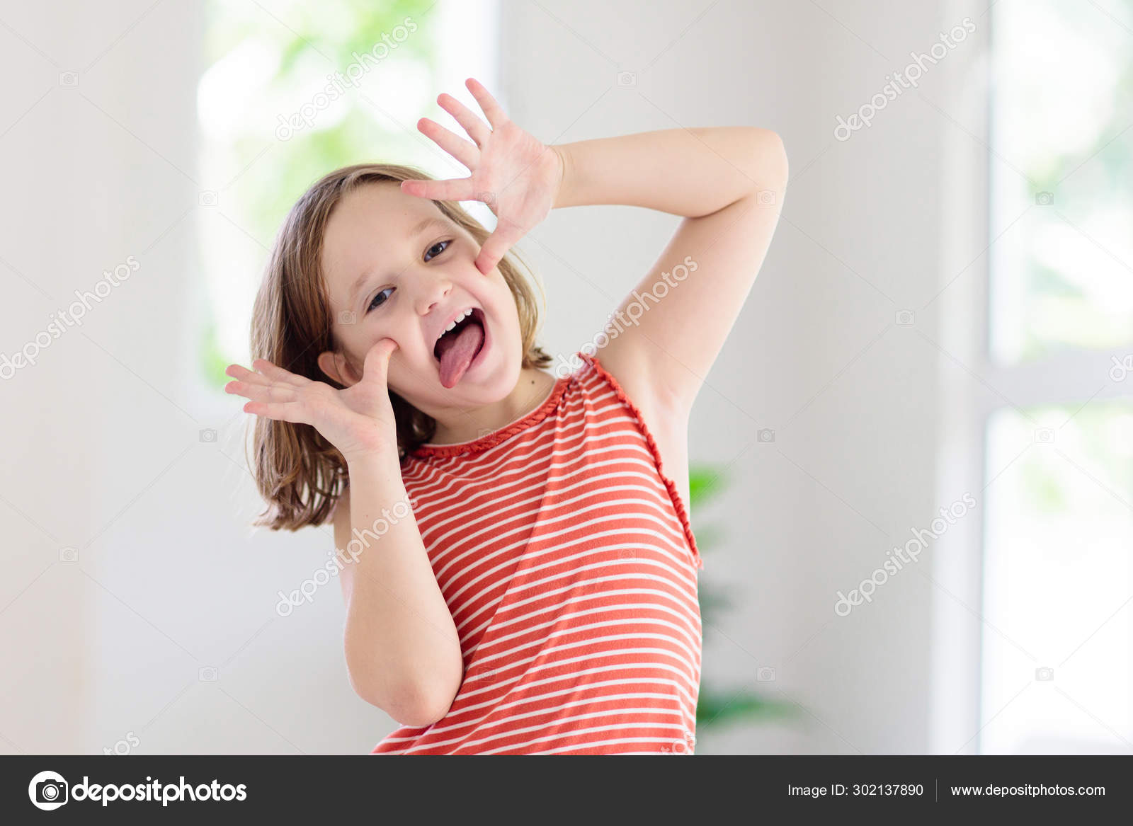 Child funny face. Kid teasing. Girl laughing. Stock Photo by ...
