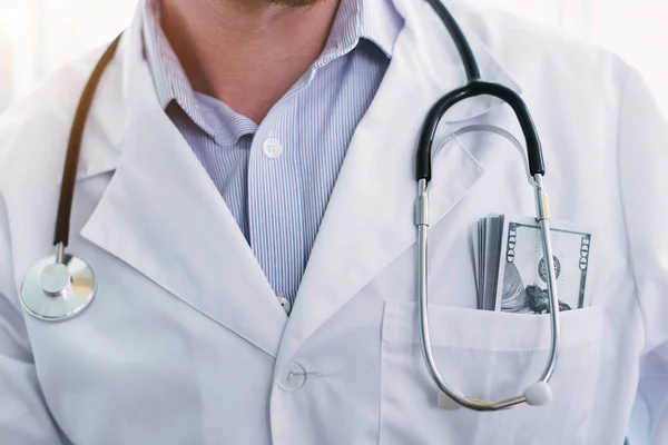 Greedy doctor taking bribes in his office - Stock Image - Everypixel
