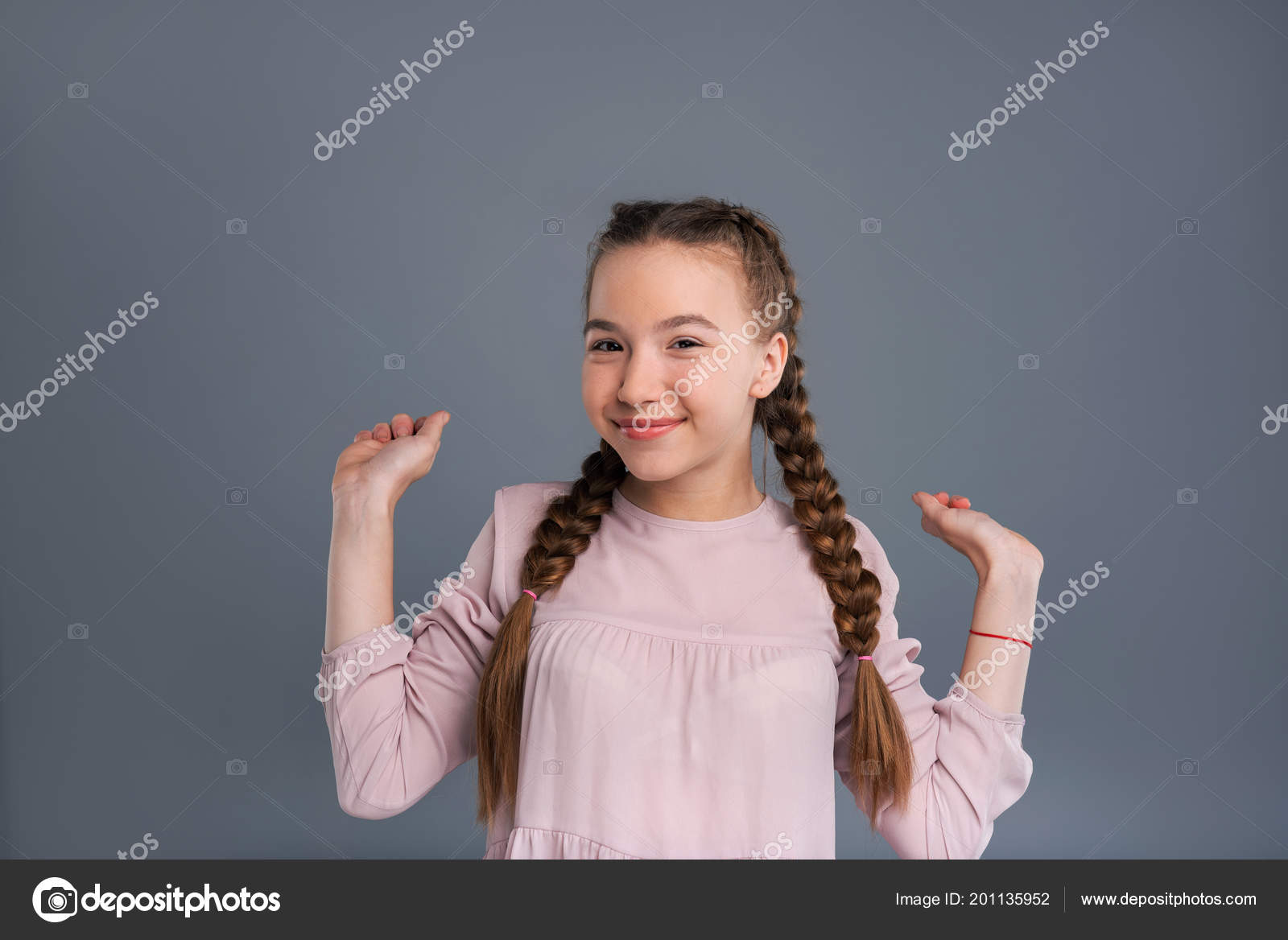 Cute cheerful girl raising her hands happily — Stock Photo © yacobchuk1 ...