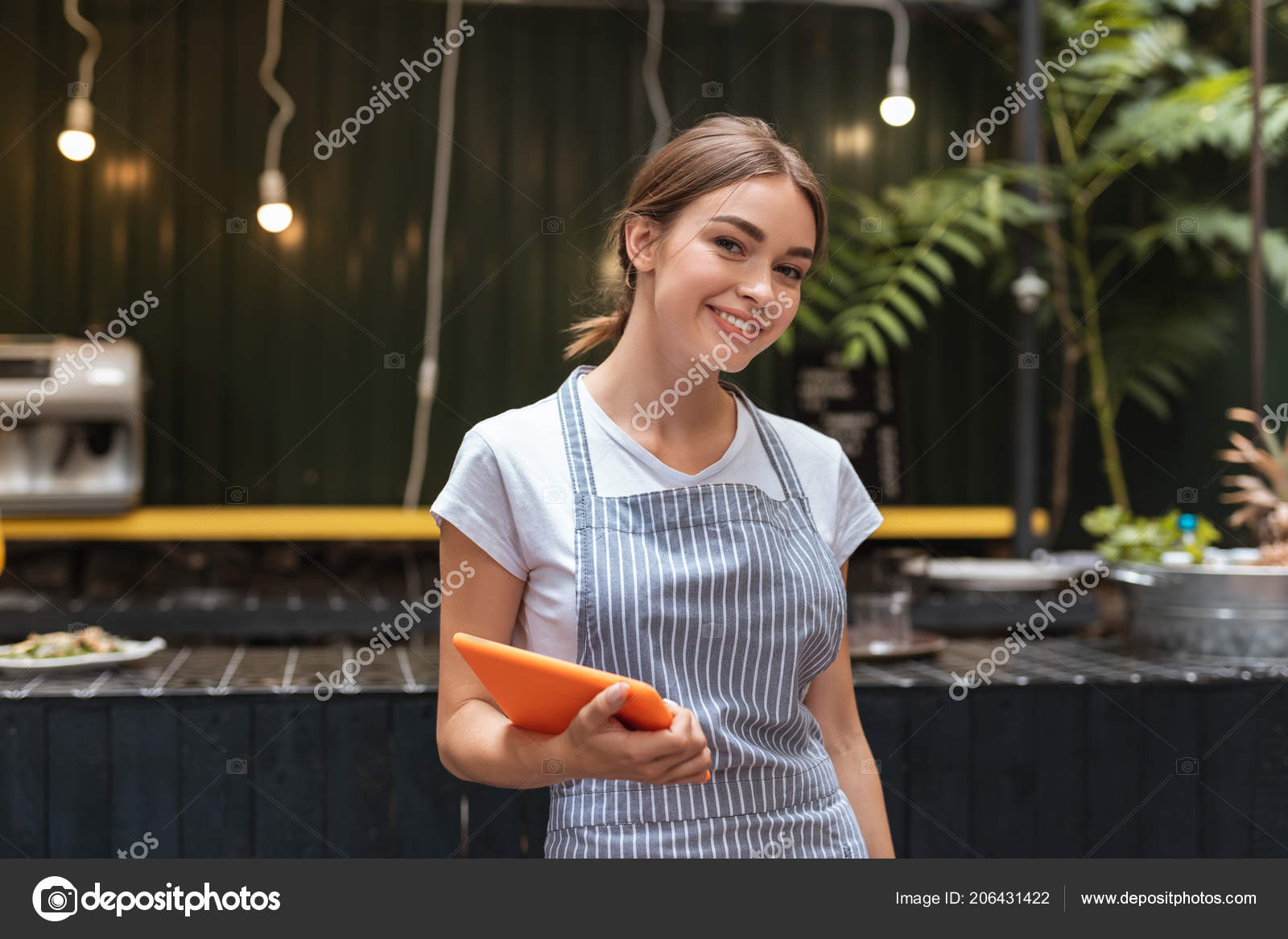 Beautiful waitress welcoming guests of restaurant — Stock Photo ...