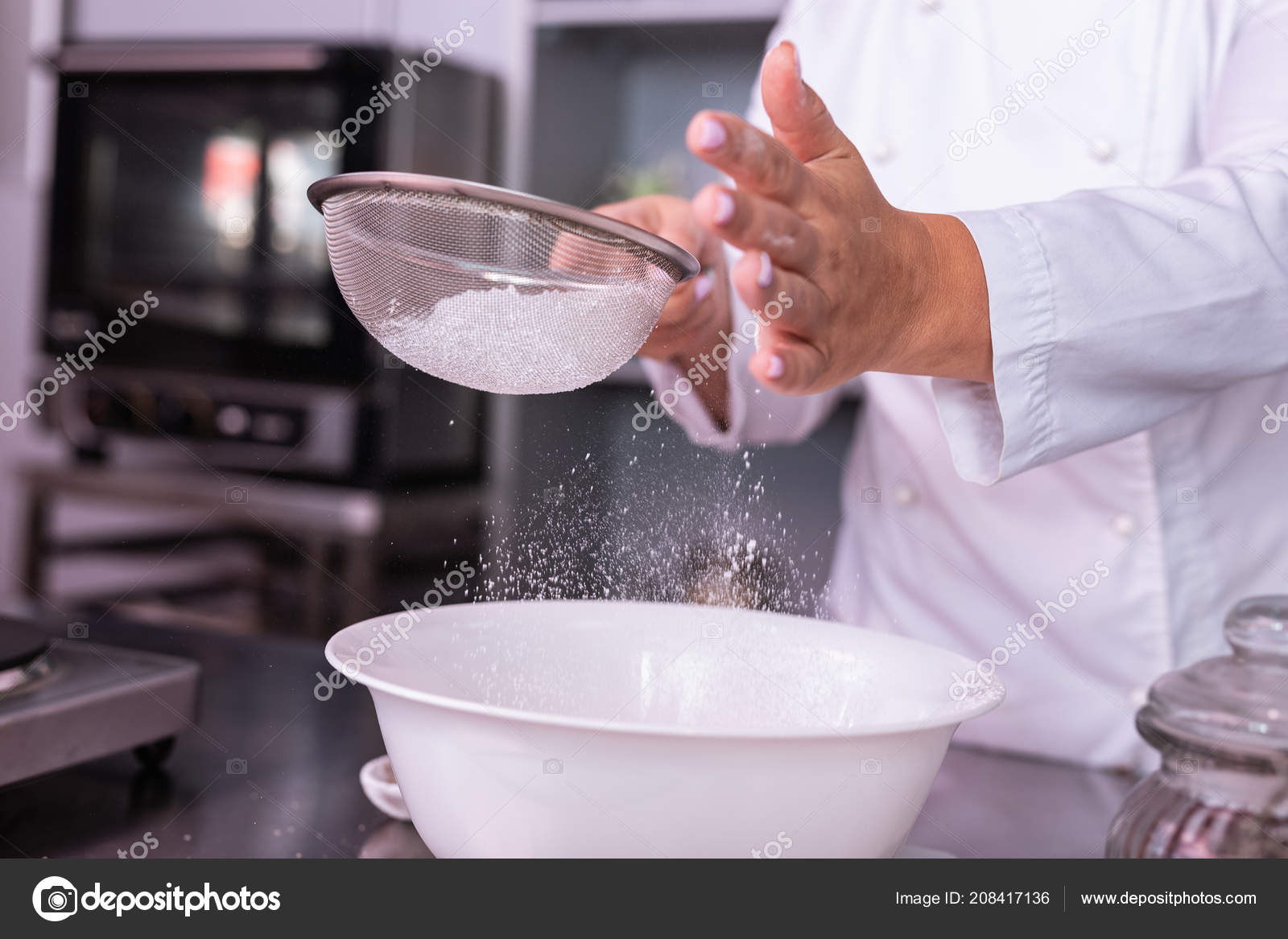 Master of confectionery sieving the flour preparing ingredients for pie ...
