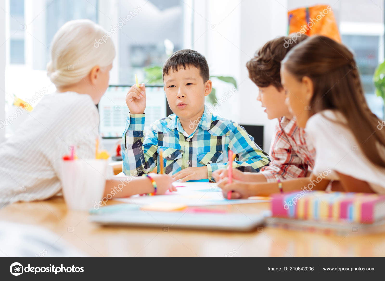 Smart schoolboy telling a story to his classmates Stock Photo by ...