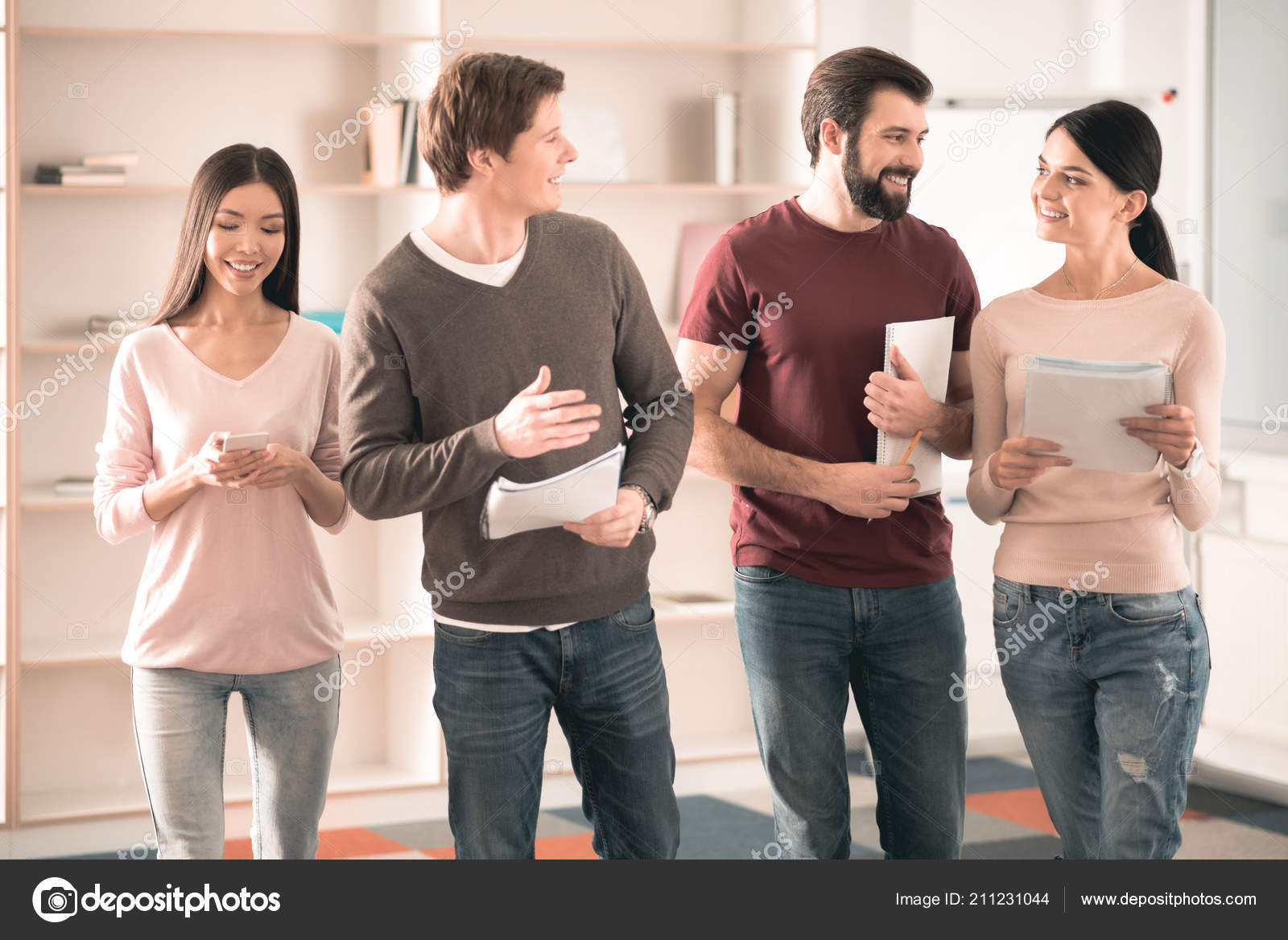 Nice young team standing together Stock Photo by ©yacobchuk1 211231044