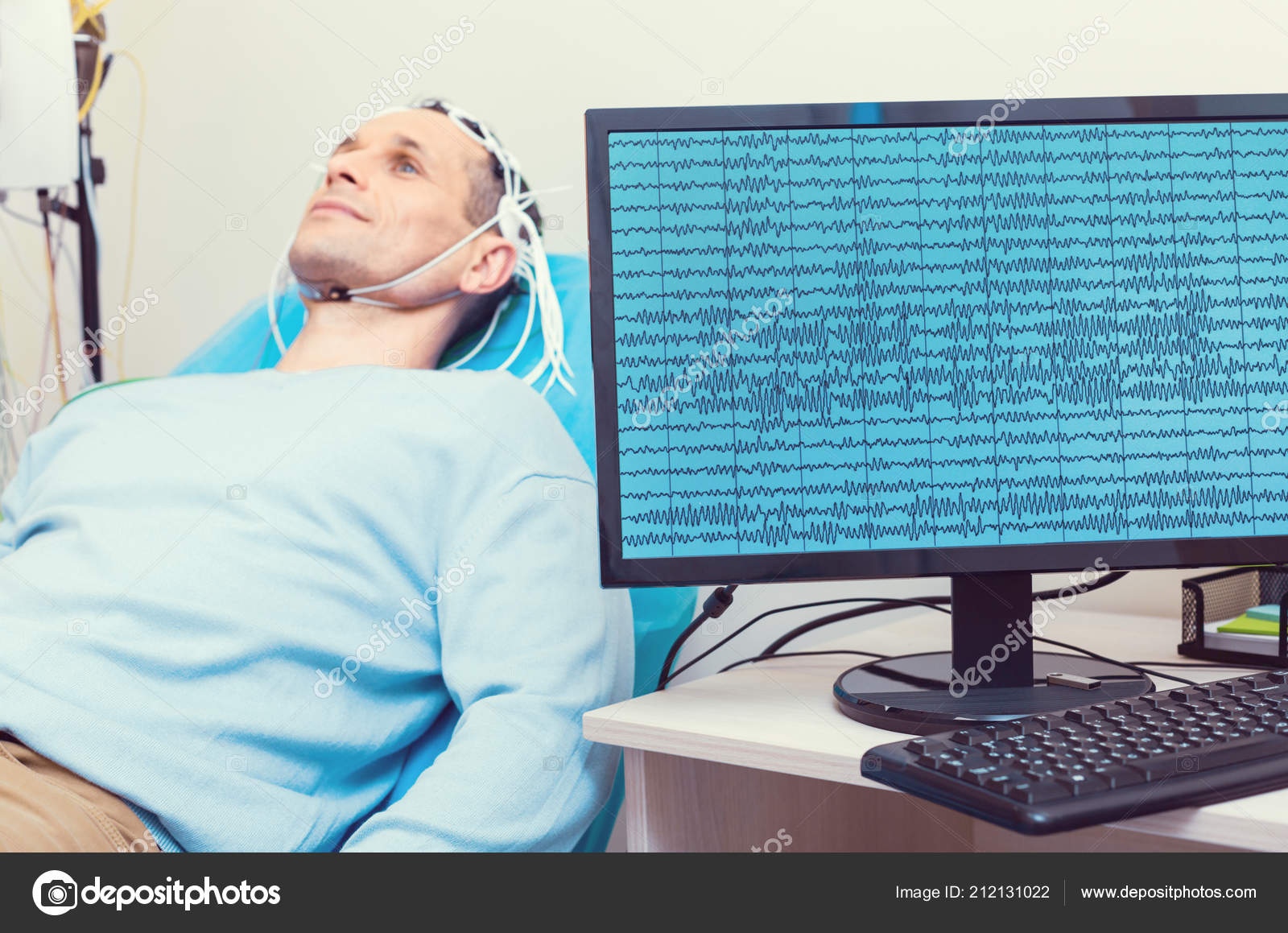 PC displaying brain waves of male patient at lab Stock Photo by ...
