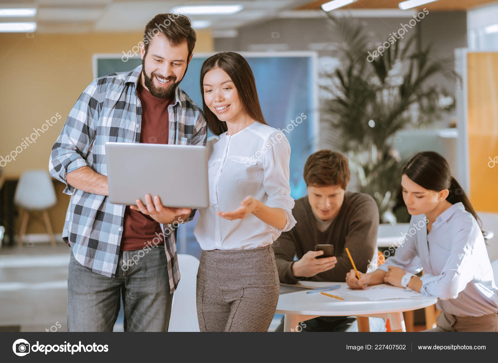 Positive two colleagues perfecting presentation Stock Photo by ...